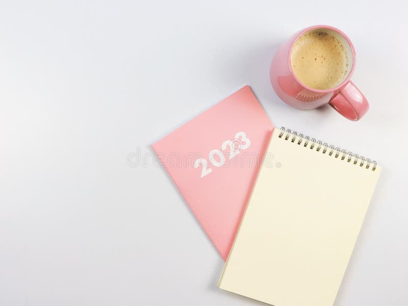 Flat Lay of Blank Paper Note Book on Pink Diary 2023 and Pink Cup of Coffee on White Background ...