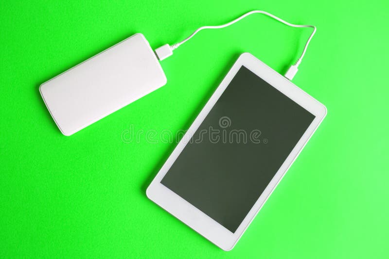 Digital Tablet with External Battery Charger Abstract Isolated on Green ...