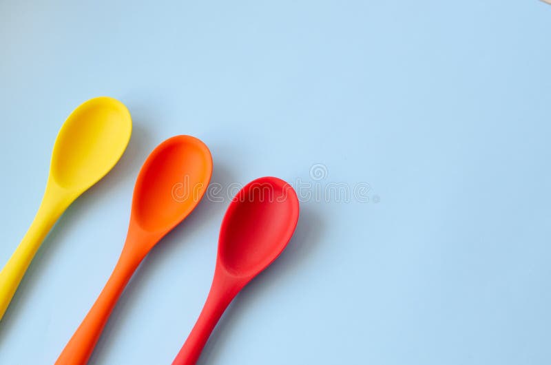 Flat Lay of Bright Multi-colored Spoons on a Blue Background Stock ...