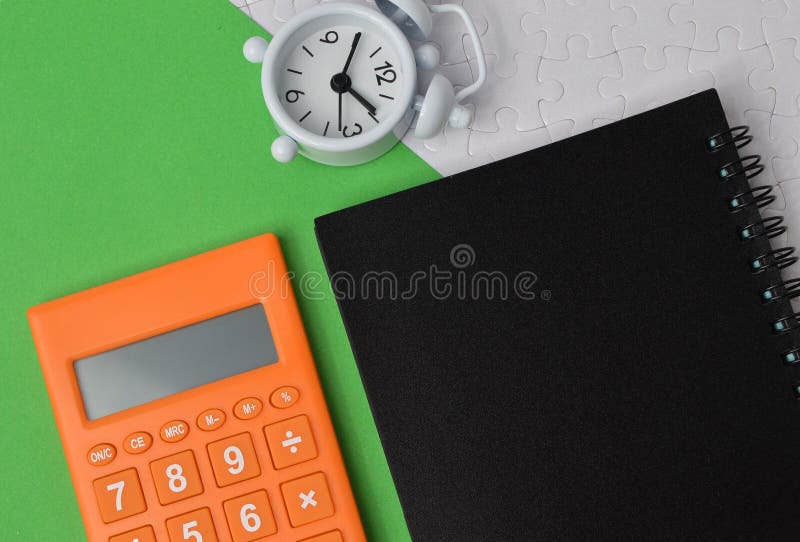 Flat Lay Closeup of an Alarm Clock, Calculator, and Notebook, the ...