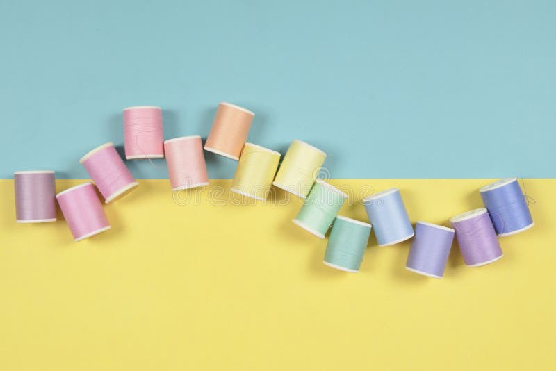 Flat Lay of Colored Thread Rolls for Sewing on Two Tone Background ...