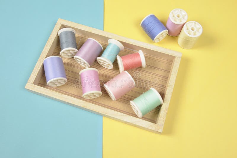 Flat Lay of Colored Thread Rolls for Sewing on Two Tone Background ...