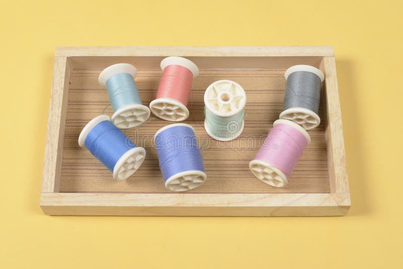 Flat Lay of Colored Thread Rolls for Sewing on Yellow Background Stock ...
