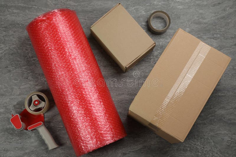 Flat Lay Composition with Bubble Wrap Roll on Grey Background Stock ...