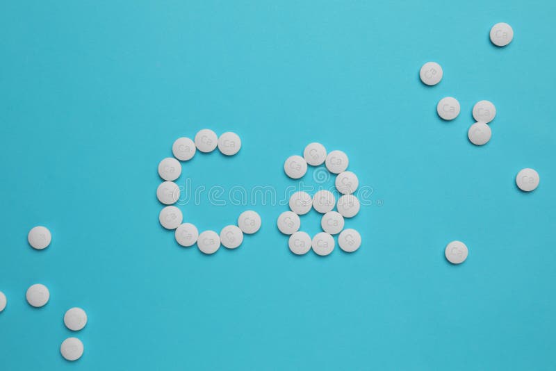 Flat Lay Composition with Calcium Supplement Pills on Light Blue ...