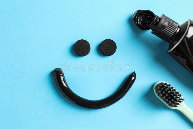 Flat Lay Composition with Charcoal Toothpaste on Light Blue Background ...