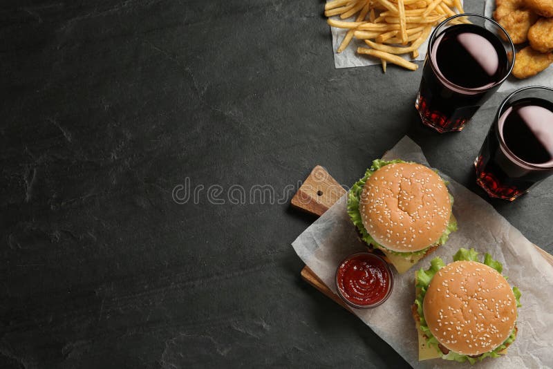 Flat Lay Composition with Delicious Fast Food Menu on Black Table ...