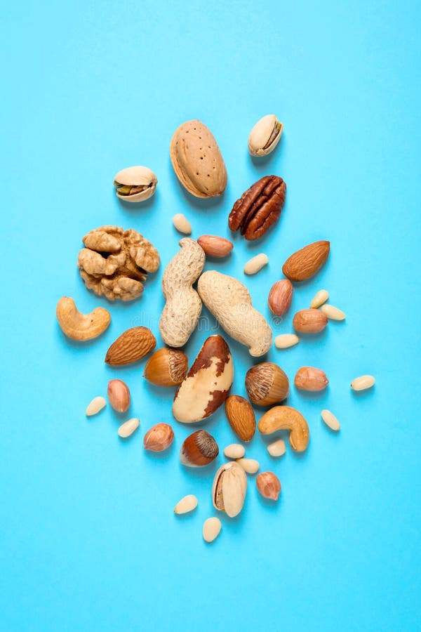 Different Nuts Falling into Pile on Background Stock Photo - Image of ...