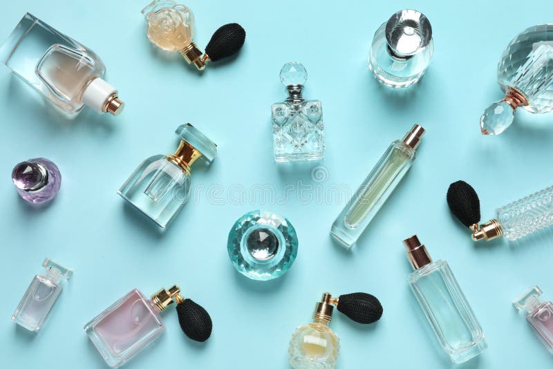 Flat Lay Composition with Different Perfume Bottles on Blue Background ...