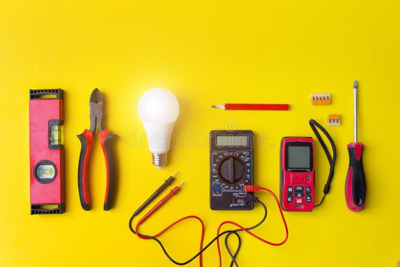 Different Electrician`s Supplies on Yellow Background. Background of ...