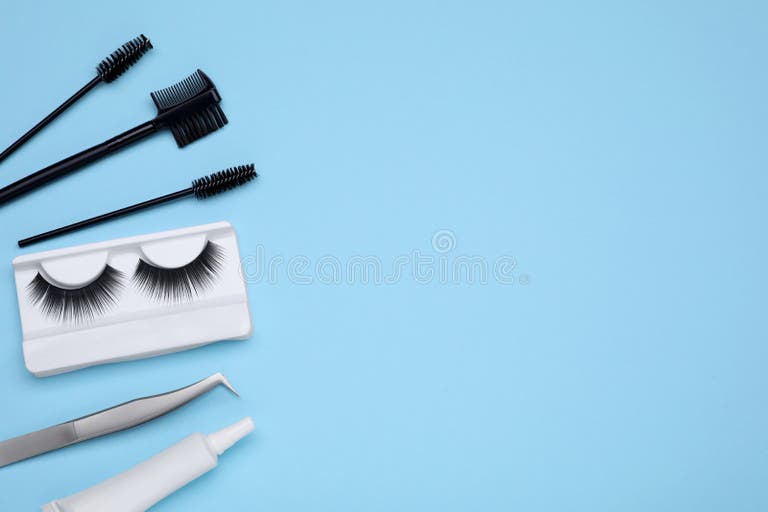 Flat Lay Composition with Fake Eyelashes on Light Blue Background ...
