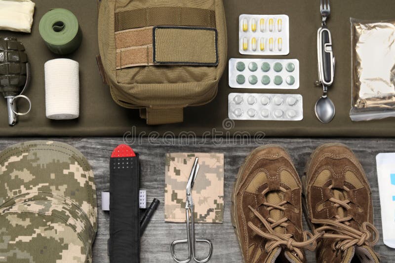 Flat Lay Composition with First Aid Kit and Army Boots on Wooden Table ...
