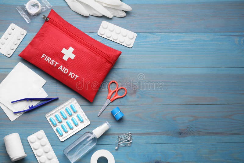 Flat Lay Composition with First Aid Kit on Blue Wooden Table, Space for ...