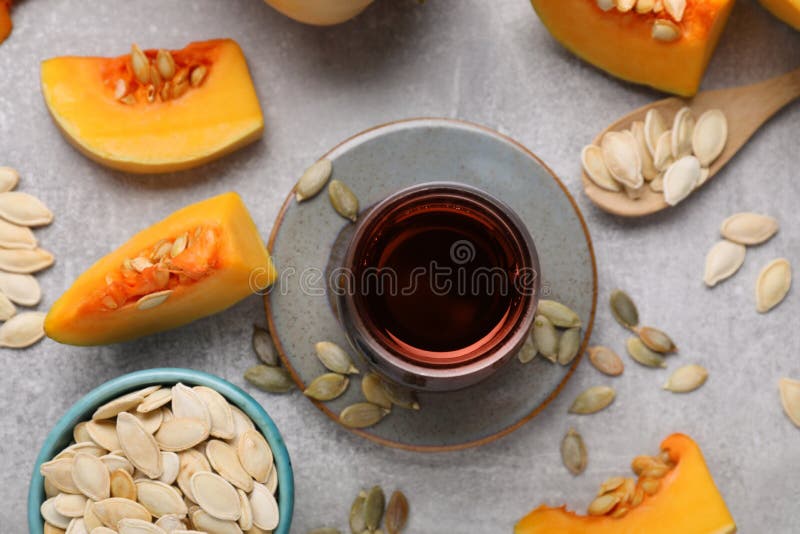 Flat Lay Composition with Glass Bowl of Pumpkin Seed Oil on Grey Table ...