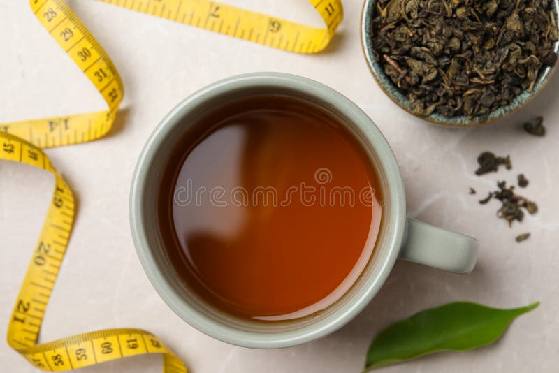 Flat Lay Composition with Herbal Diet Tea and Measuring Tape on Light ...