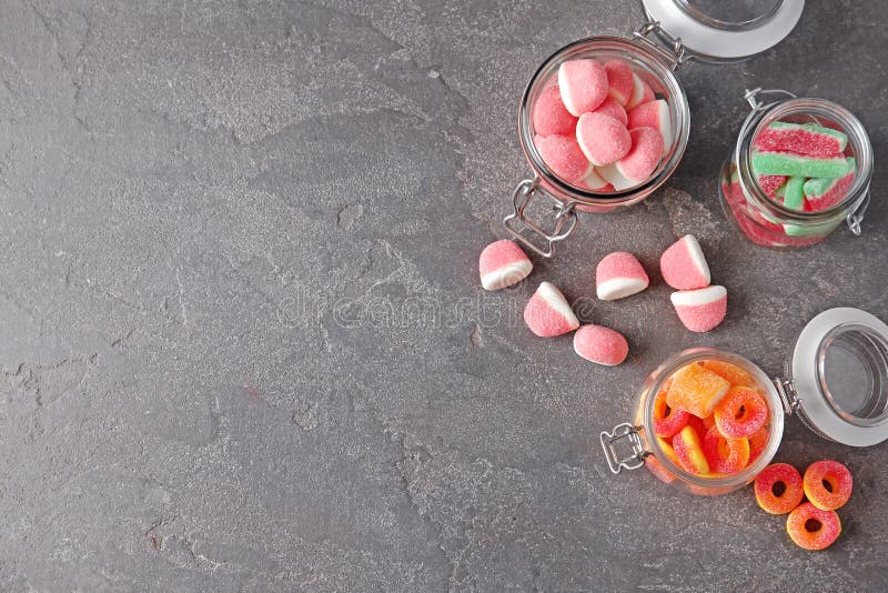 Flat Lay Composition with Jars of Tasty Jelly Candies on Grey Table ...