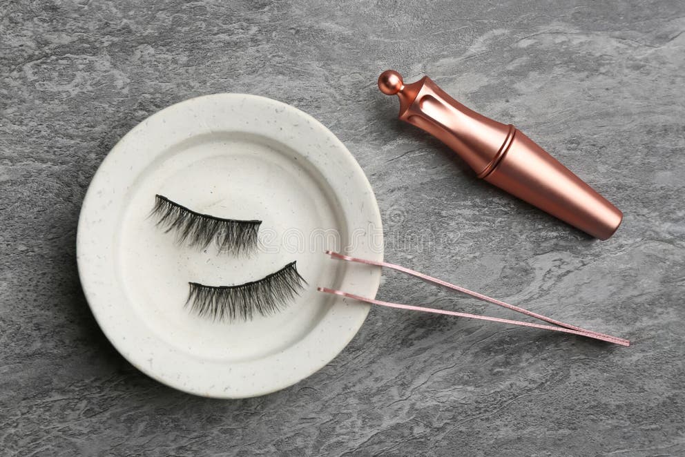 Flat Lay Composition with Magnetic Eyelashes and Accessories on Grey ...