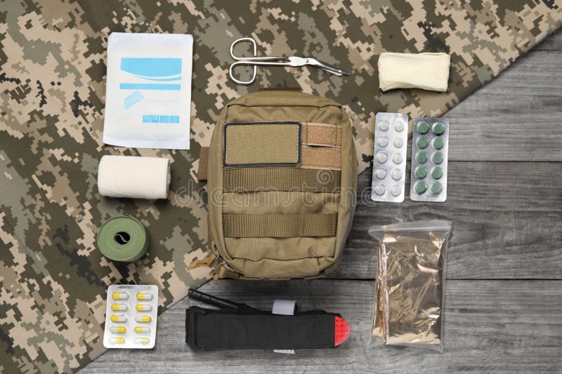 Flat Lay Composition with Military First Aid Kit on Wooden Table Stock ...