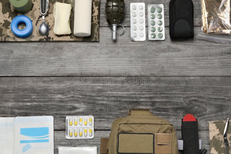 Flat Lay Composition with Military First Aid Kit on Wooden Table. Space ...
