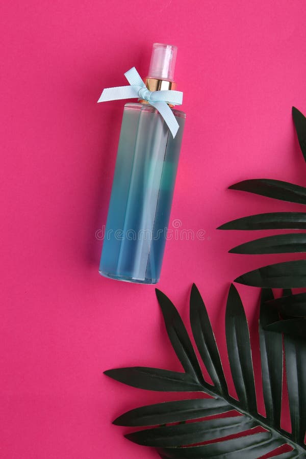 Flat Lay Composition with Perfume Bottles and Leaves on Light Pink ...