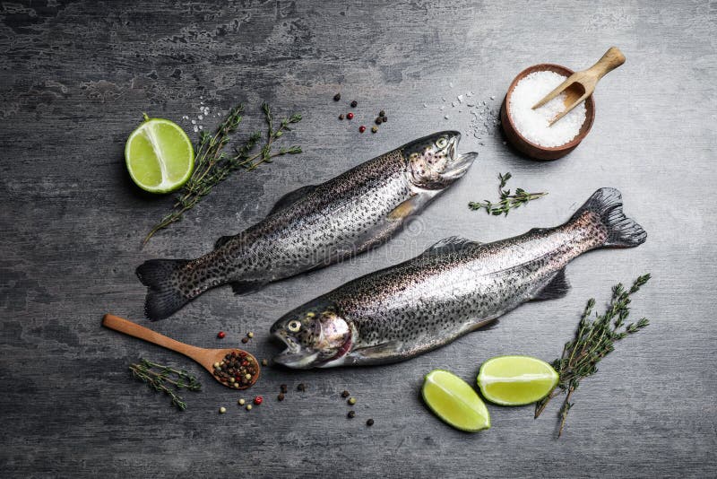 Flat Lay Composition with Raw Cutthroat Trout Fish on Table Stock Image ...