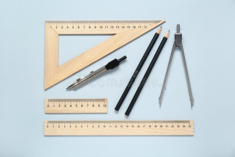 Flat Lay Composition with Rulers and Compasses on Light Grey Background ...