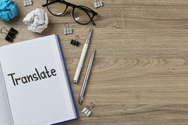 Flat Lay Composition with Word Translate Written in Notebook on Table ...