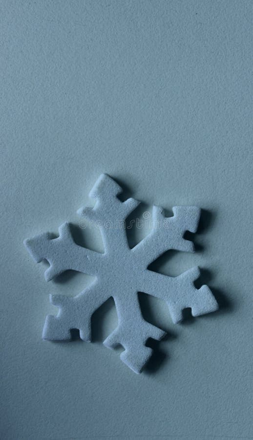 Vertical Winter Background with Toy Snowflake on Light Blue Surface ...