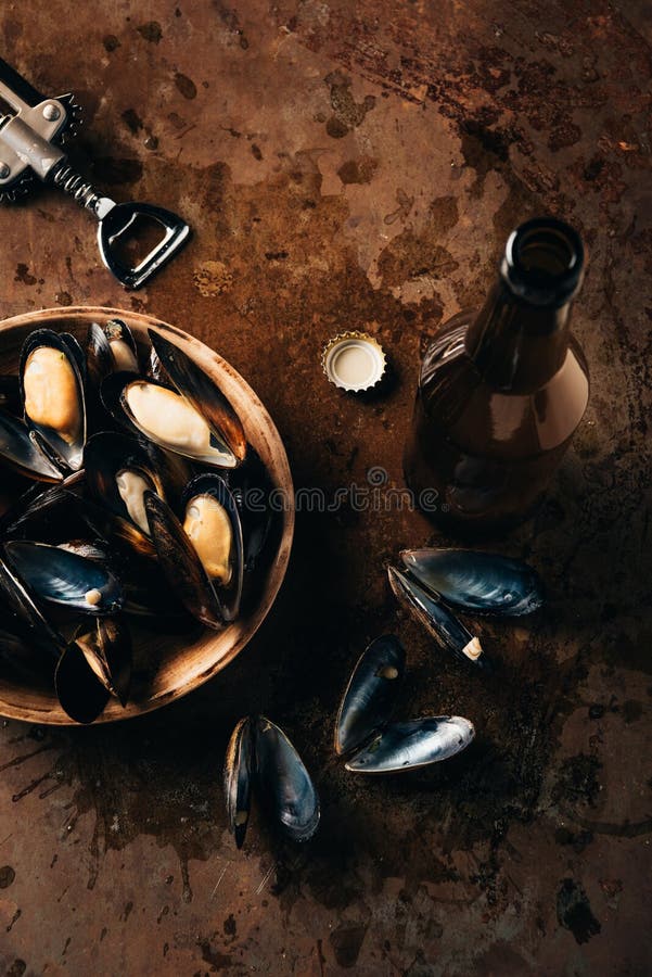 Flat Lay with Opened Glass Bottle of Beer Bottle Opener and Mussels in ...