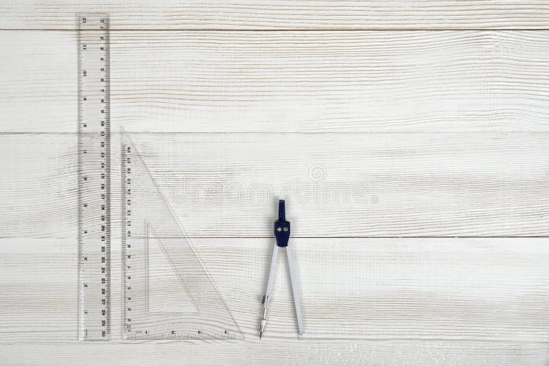 Flat Lay of Riangle Centimeter Rulers and Engineering Divider on Wooden ...