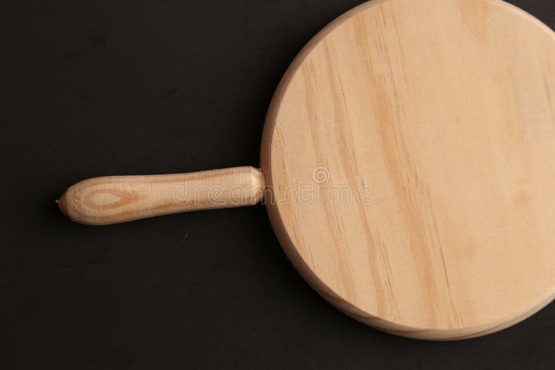 Flat Lay Shot of a Chopping Board with a Handle on a Black Surface ...