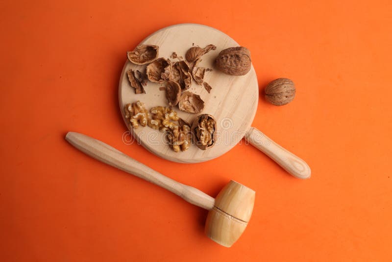 Flat Lay Shot of a Wooden Nut Hammer and a Board with Broken Nuts on it ...