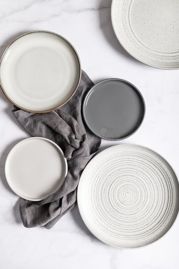 Trendy grey ceramic plates stock photo. Image of dish - 274120914