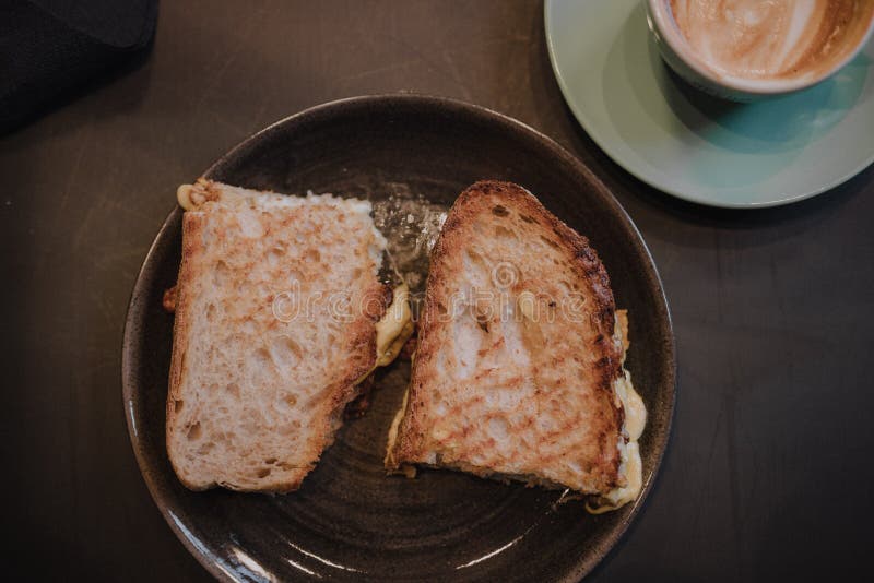 Flat Lay View of a Half Full Cup of Coffee and Toasted Cheese Bread ...