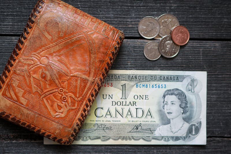 Wallet, Canadian Dollar Bill and Coins on a Rustic Wood Background ...