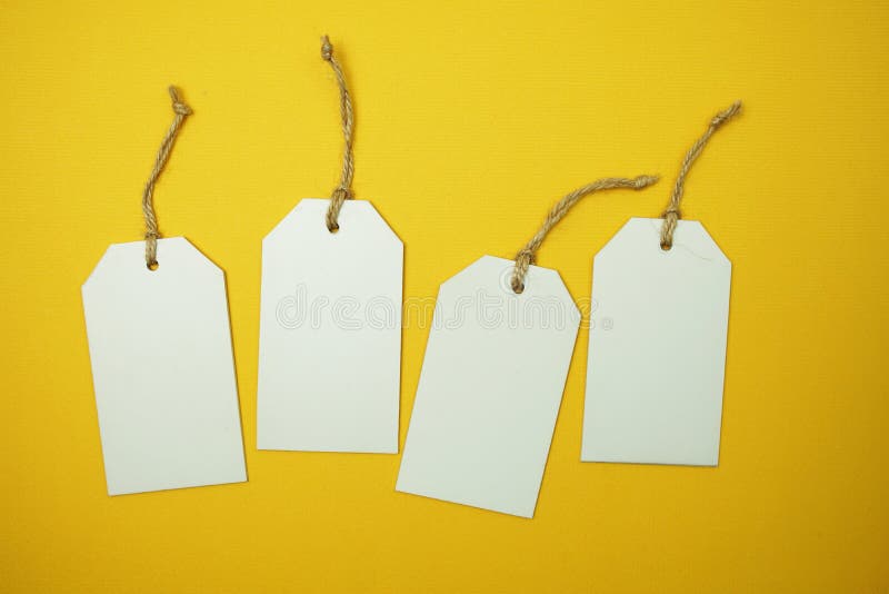 Flat Lay White Blank Tag on Yellow Background Stock Image - Image of ...