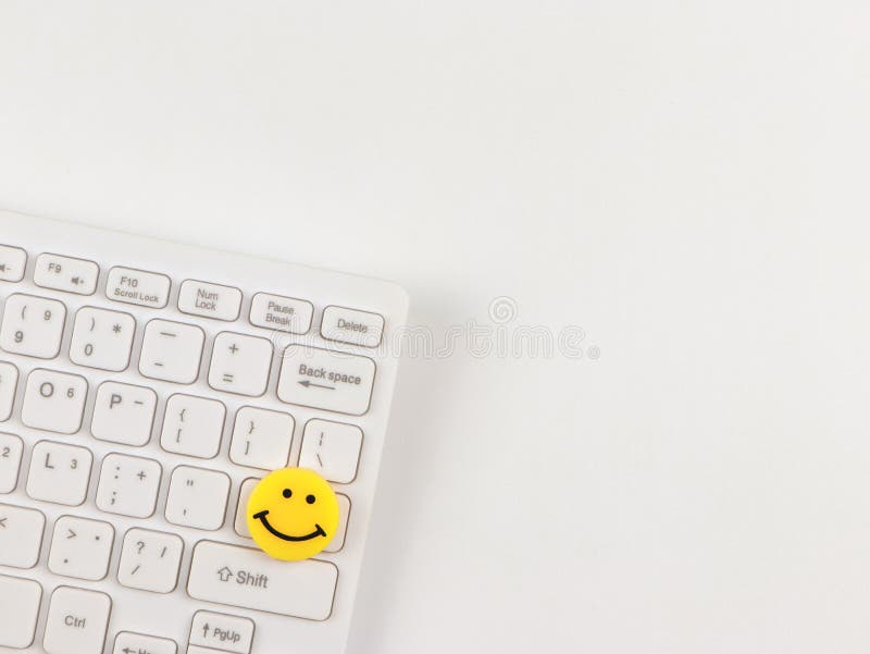 Flat Lay of Yellow Circle Smiling Face on White Computer Keyboard on ...
