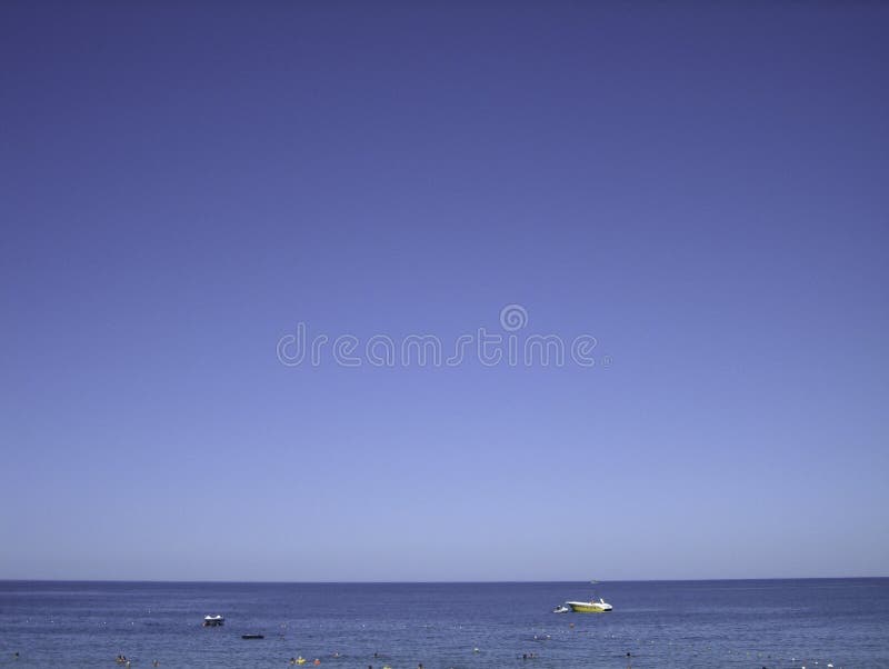 The Flat Line of the Sea Horizon between the Cloudless Sky and the Blue ...
