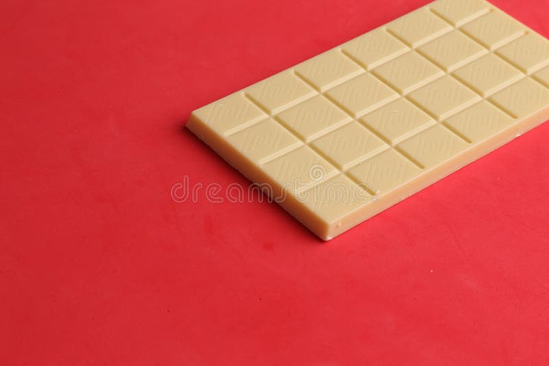 Flat Long Bar of White Chocolate on a Red Surface Stock Image - Image ...