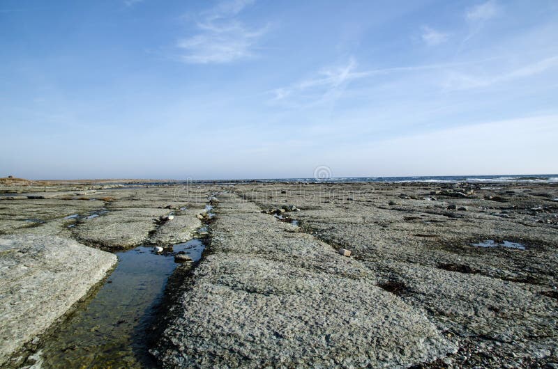 Flat rock coast stock image. Image of blue, scenery, rocky - 38249427