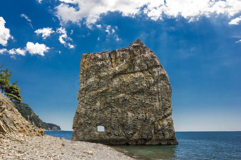 Flat Rock Vertical Standing Alone in Sea on Coast on Clear Day Stock ...