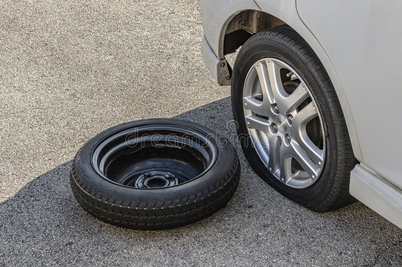 Flat Tire and Donut Spare with Copy Space Stock Image - Image of ...
