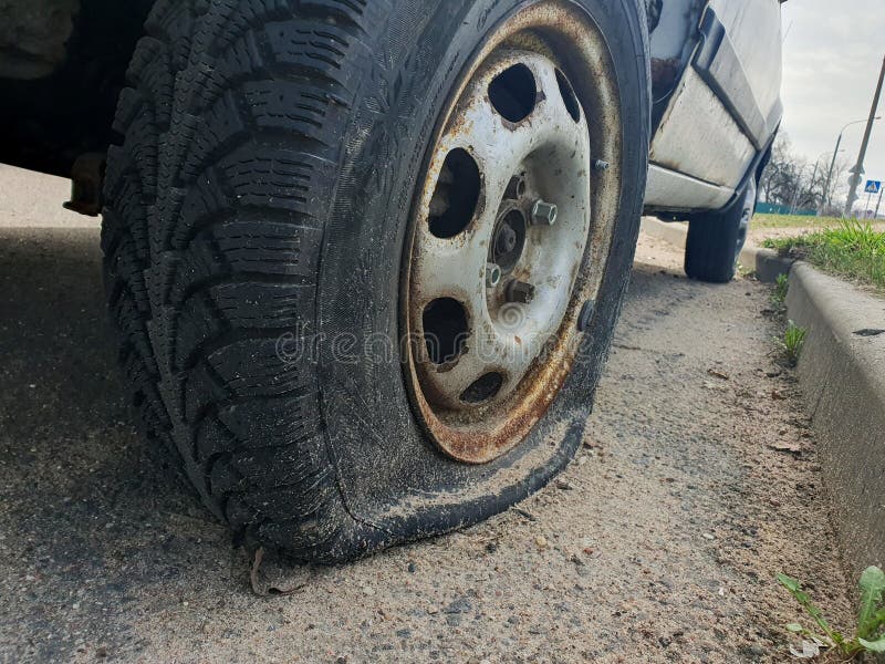 Flat Tyre on Road. Car Tire Leak because of Nail Pounding Stock Image ...