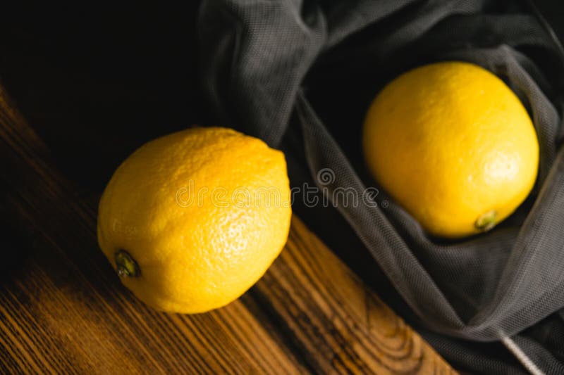 Flatlay, Lemons on a Cutting Board and in a Fruit Net on a Dark ...