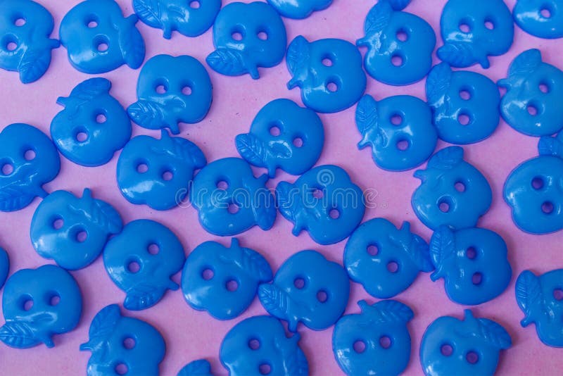 Flatlay Top View of Blue Color Apple Shape Button on Pink Back Stock ...
