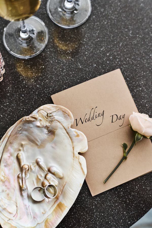 Flatlay of Wedding Composition of Pearl Shell with Rings, Invitation ...
