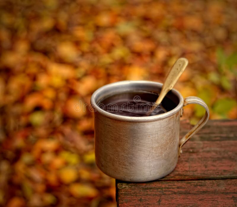 Flavored Tea in a Metal Mug on an Old Table in the Background of Autumn ...