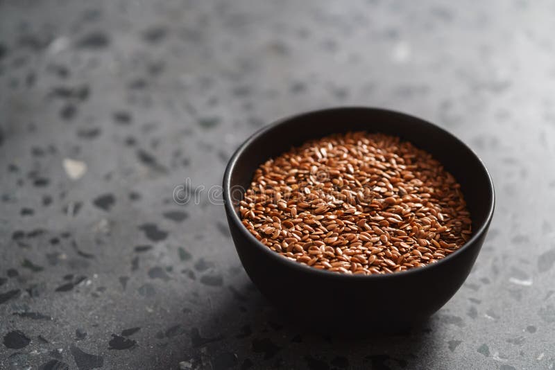 Flax Seeds in Black Bowl on Terrazzo Surface with Copy Space Stock ...