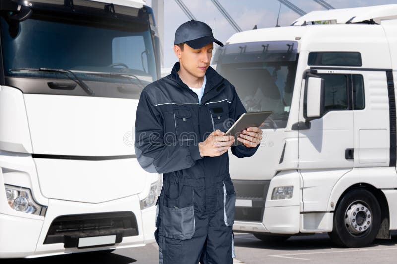 Fleet Manager with Digital Tablet on a Background of Trucks Stock ...