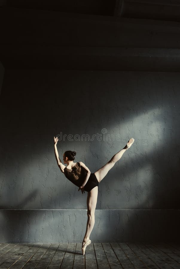 Flexible Ballet Dancer Stretching in the Dark Lighted Studio Stock ...